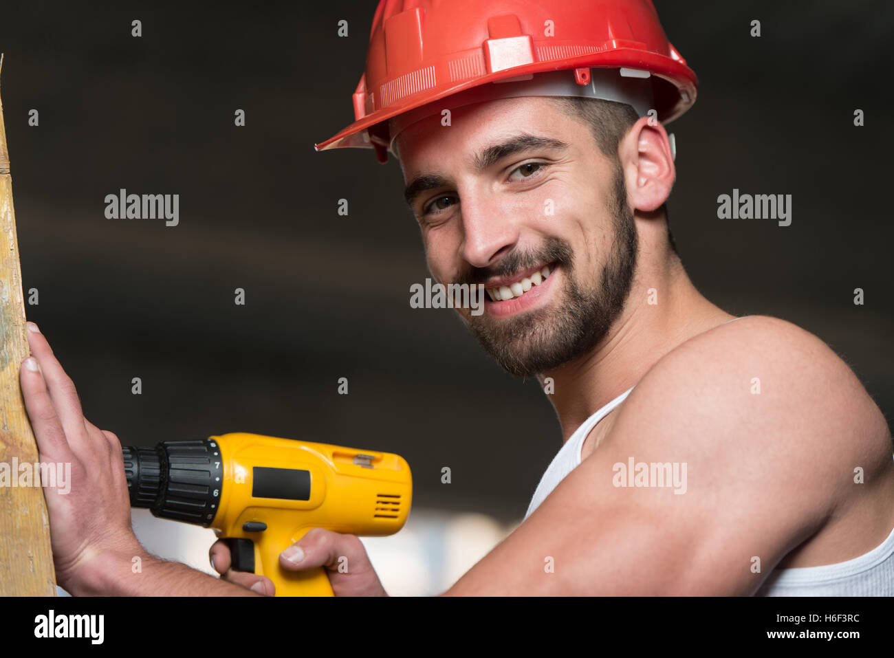Successful Male Architect At A Building Site Trying To Drill A Large ...