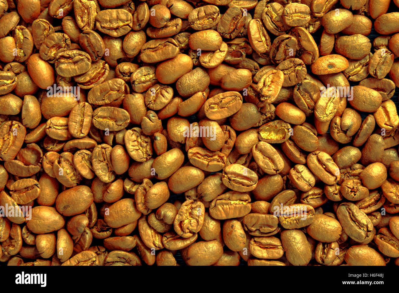 Gold coffee beans as background macro Stock Photo - Alamy