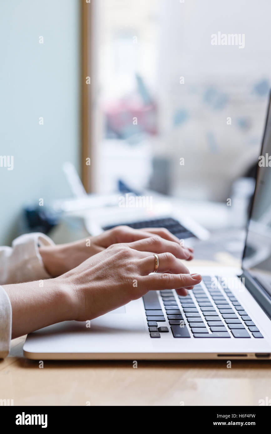 Person writing on laptop Stock Photo - Alamy