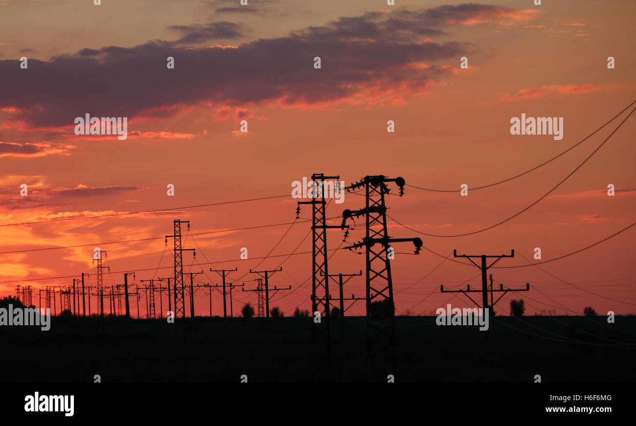 Power line at sunset Stock Photo - Alamy