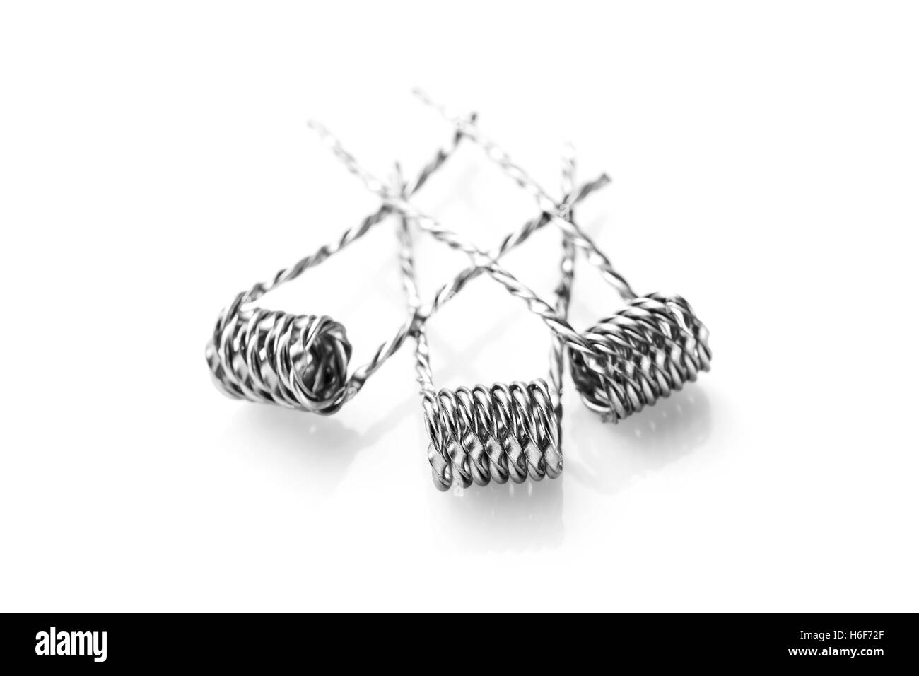 Mix twisted coils for vaping on a white background macro closeup wire ...