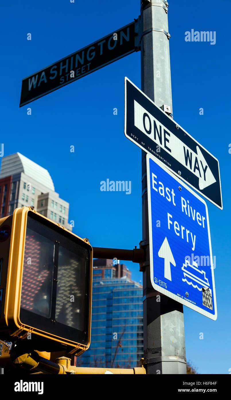 Sign on a traffic light post directing the way to the East River ferry ...