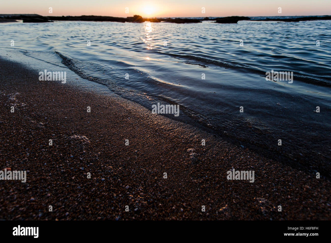 Evening light falling on the dark yellow sand at the beach Stock Photo ...
