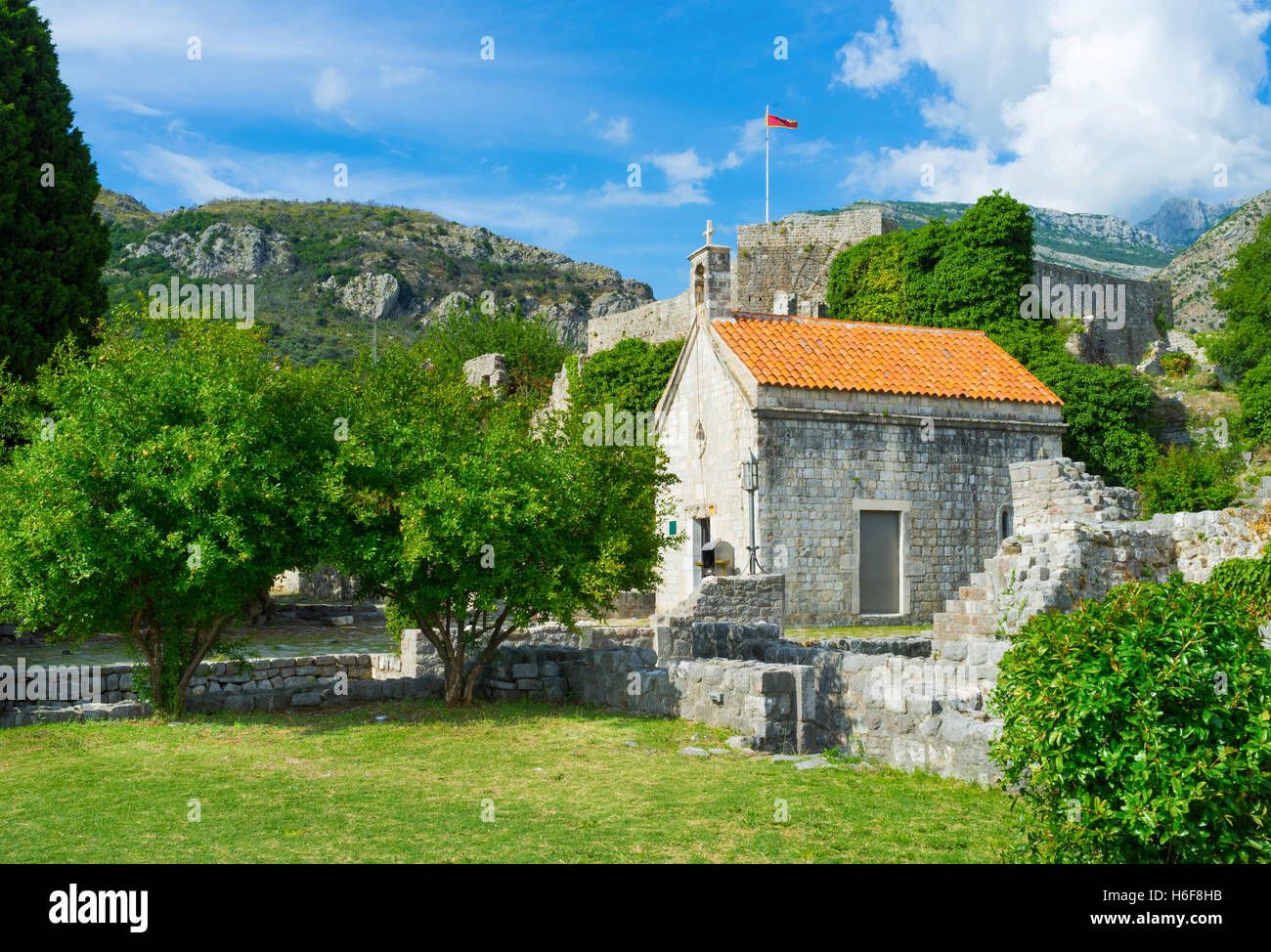 The small stone church surrounded by scenic green garden, Stari Bar ...