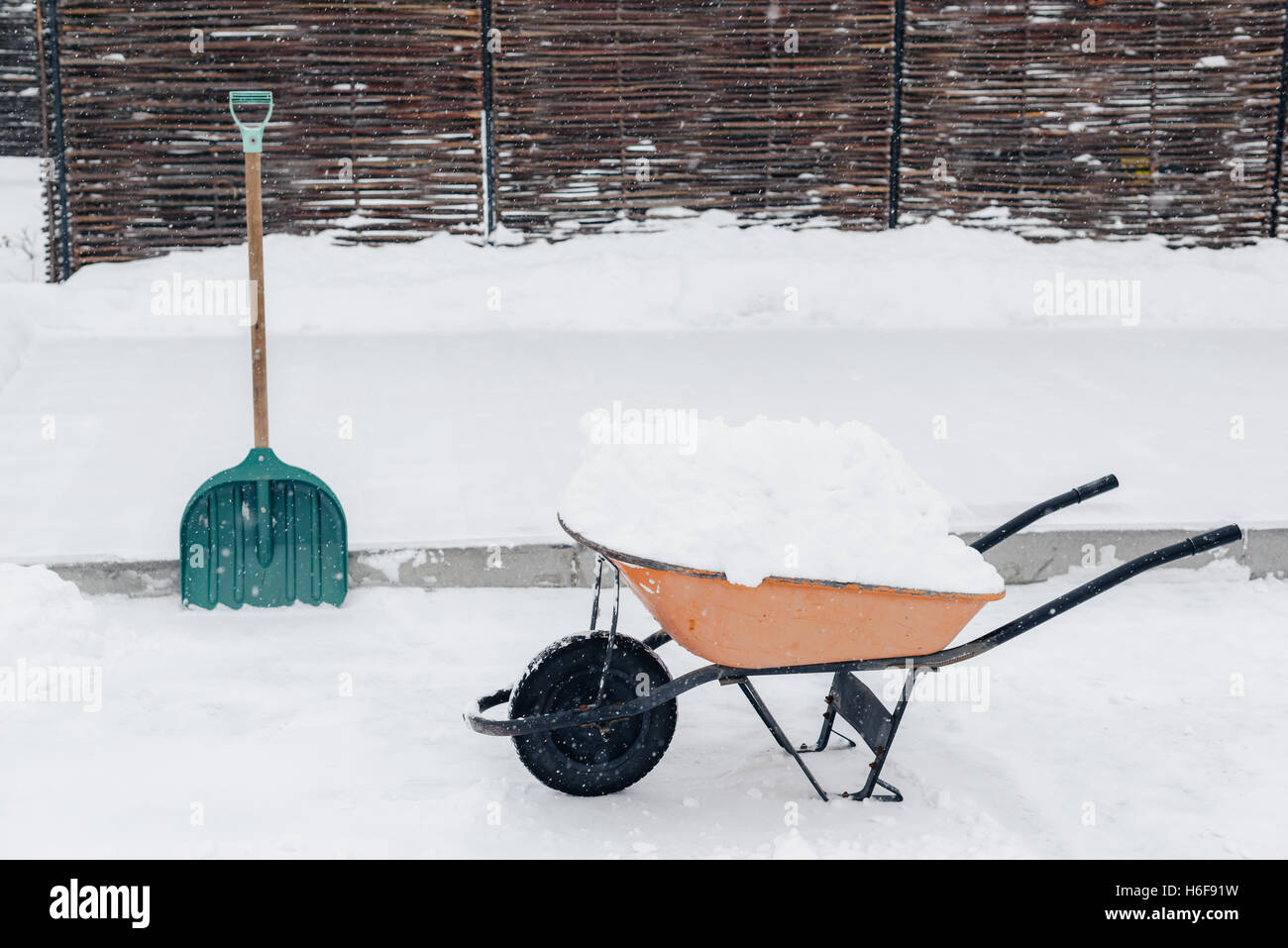 Wheelbarrow with snow Stock Photo - Alamy