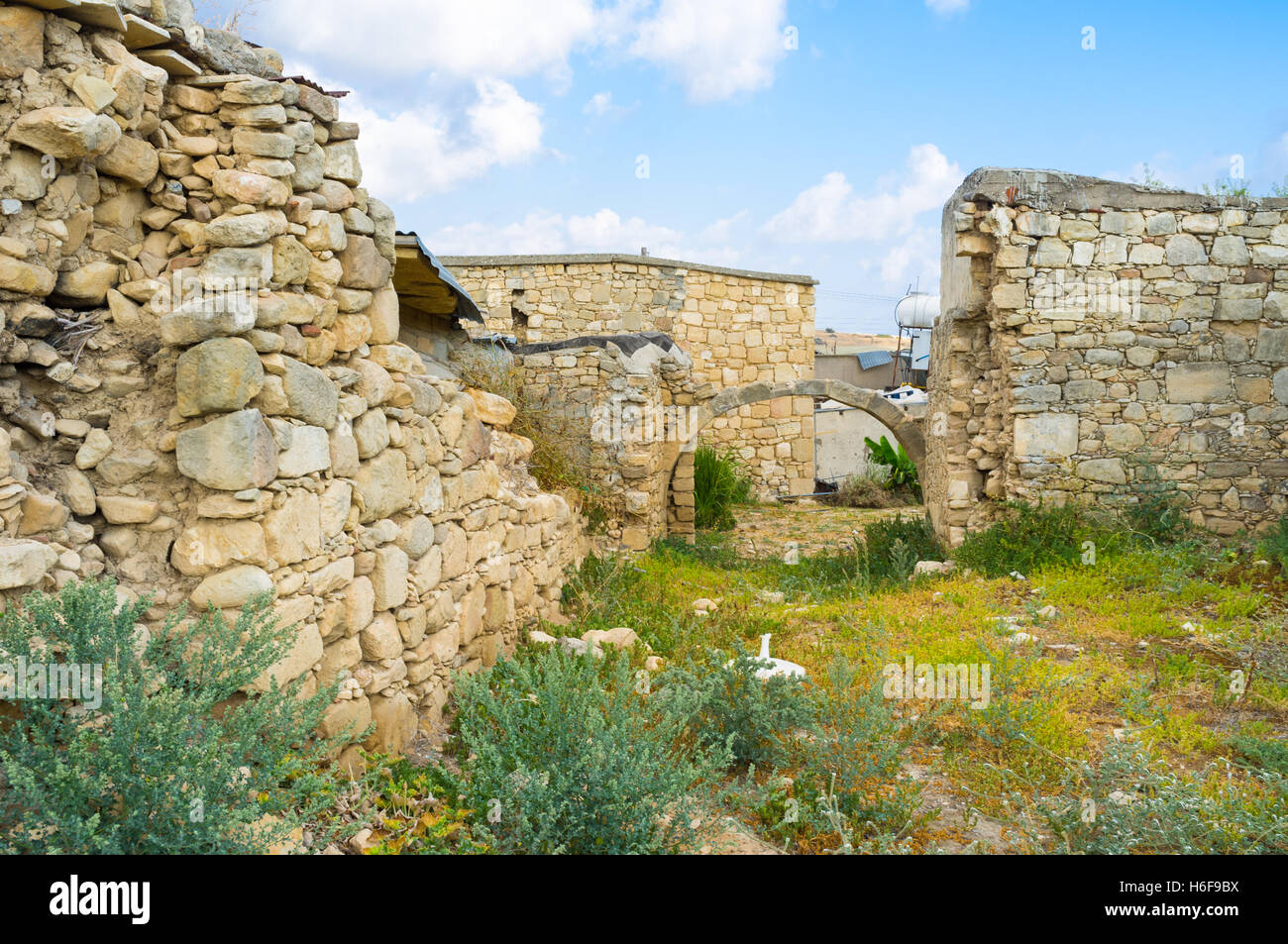 The ruins of the old residential house with preserved stone wall and ...