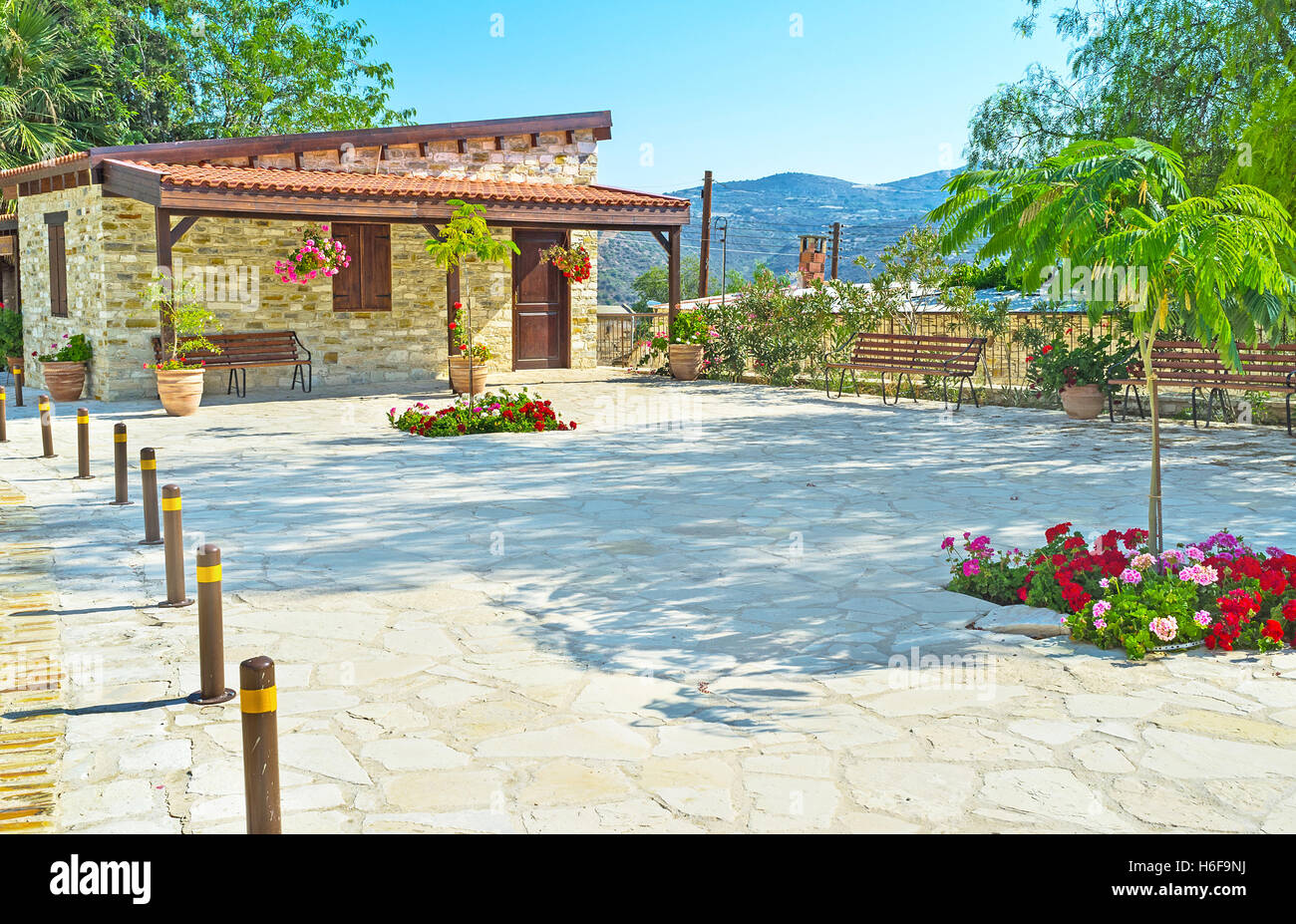 The park in Kato Drys, decorated with the bright flowers and tiny trees ...