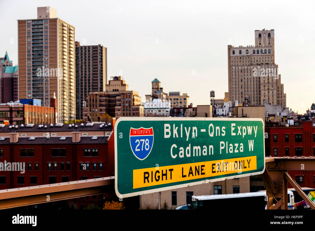 Sign above a highway depicting the way to the Brooklyn-Queens ...