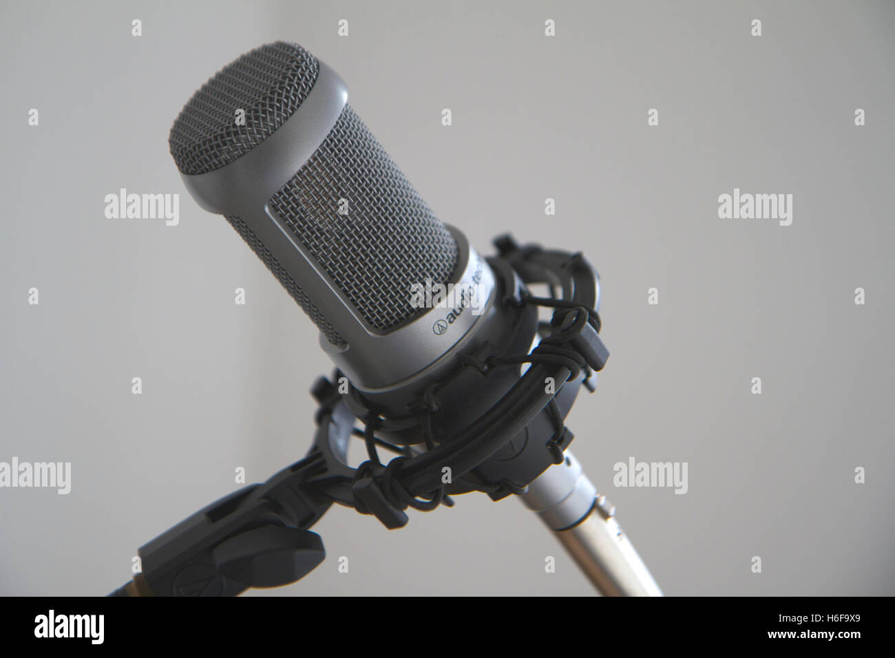 silver audio technica microphone on a black stand Stock Photo - Alamy