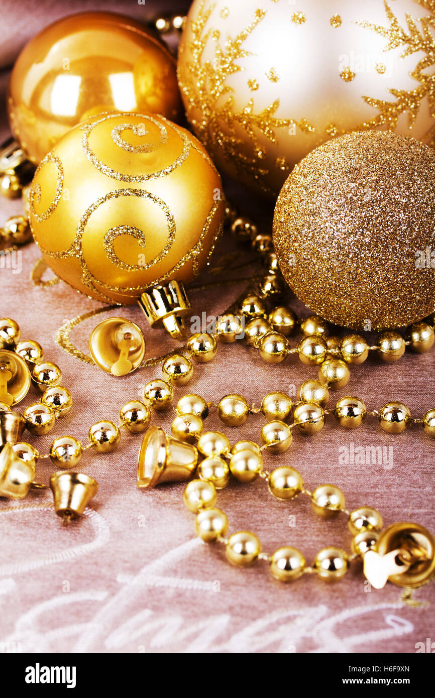 Festive gold Christmas decorations on a fabric background Stock Photo ...