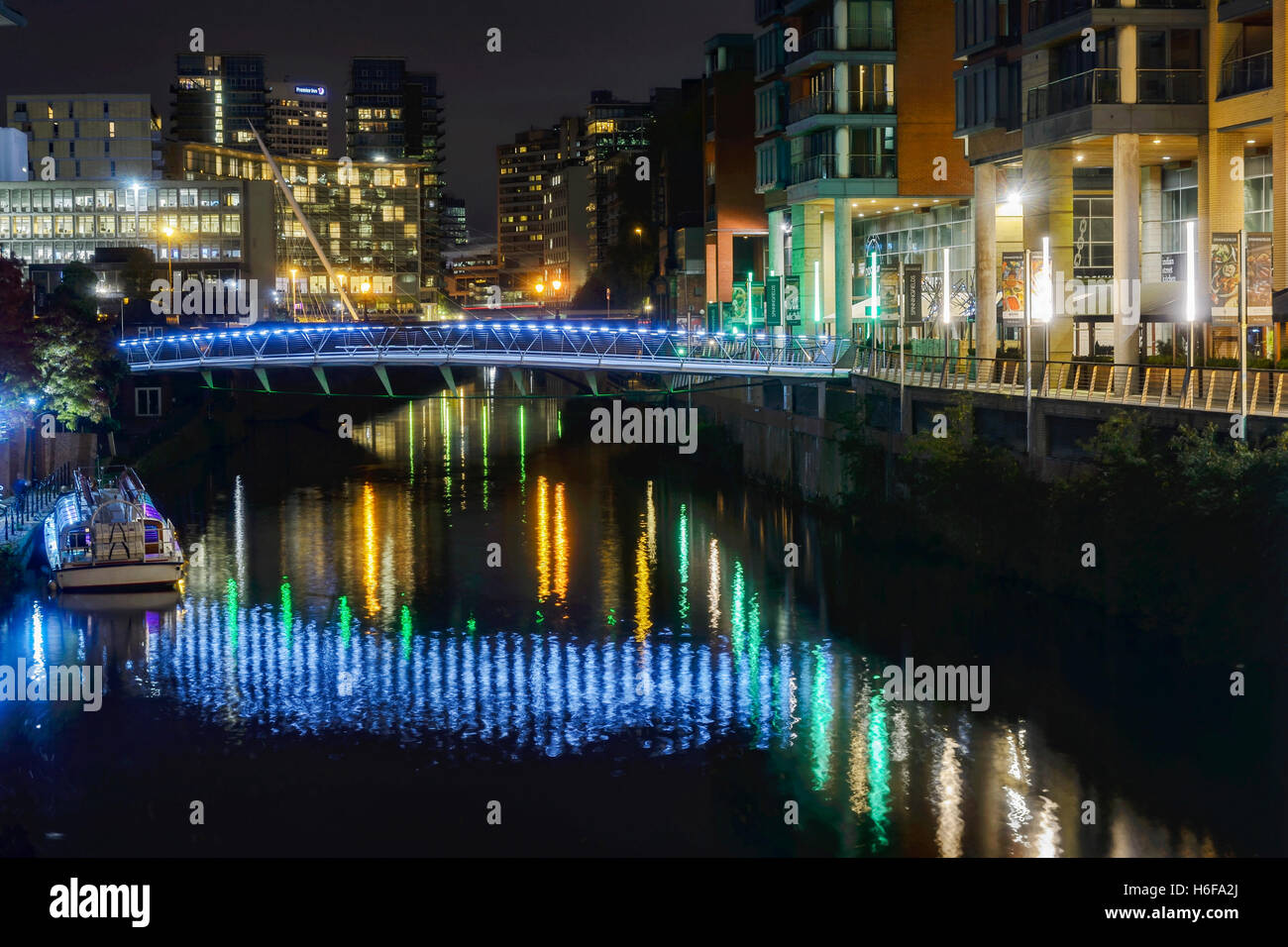 Illuminated footbridge crossing the River Irwell joining Spinningfields ...