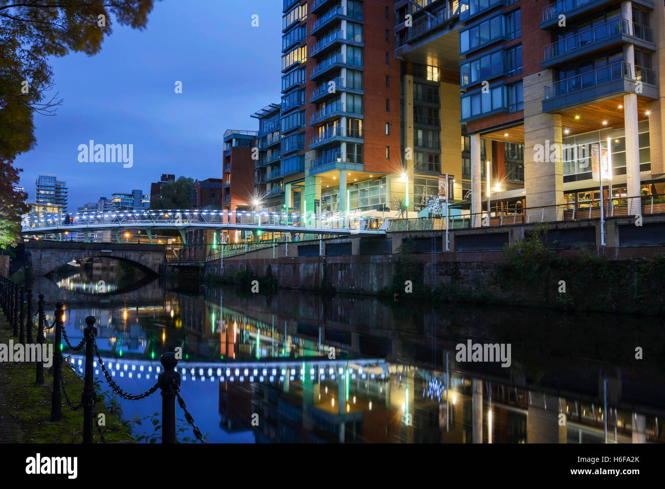 Illuminated footbridge crossing the River Irwell joining Spinningfields ...