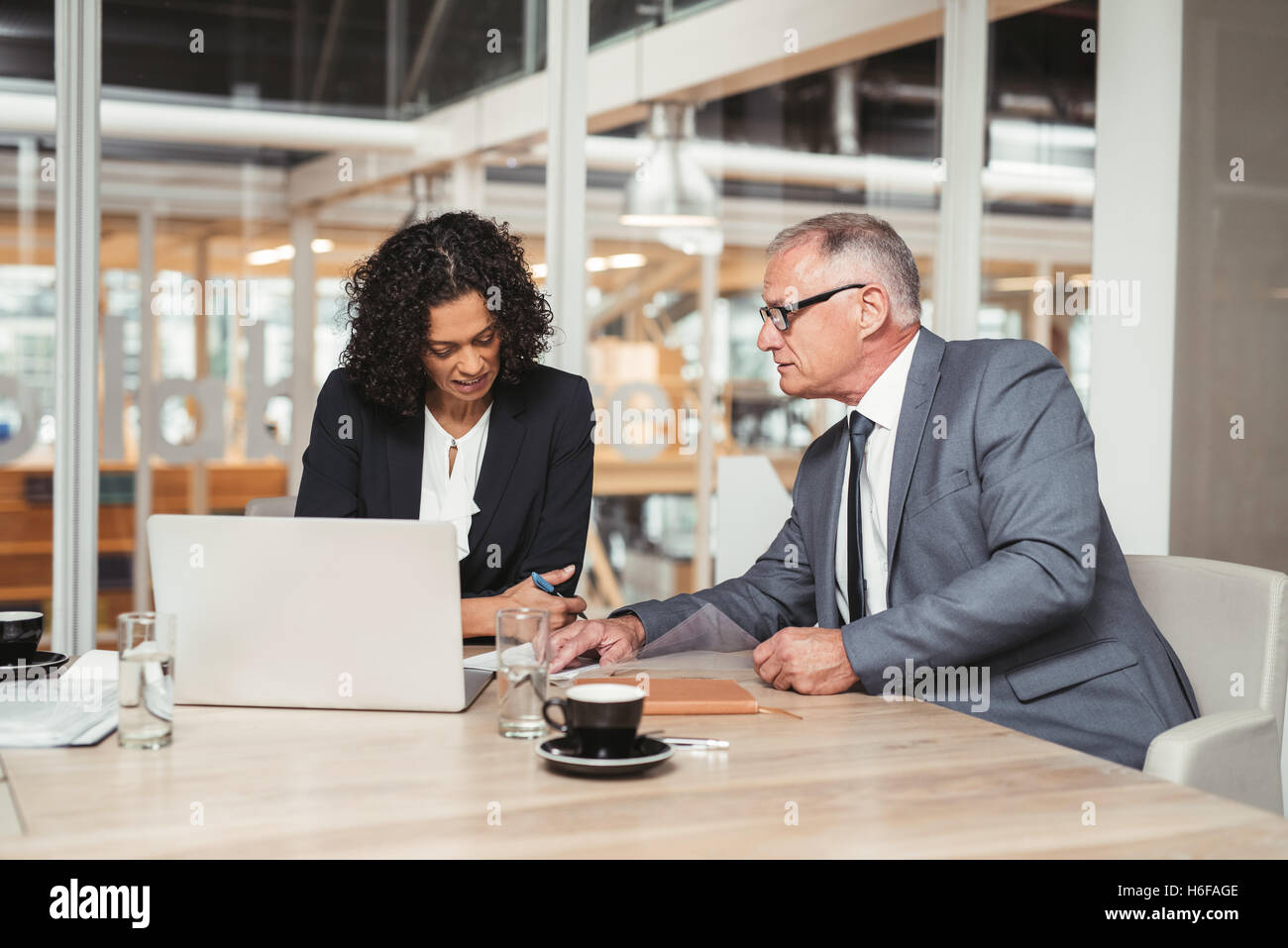 Offering some advice to a younger colleague Stock Photo - Alamy
