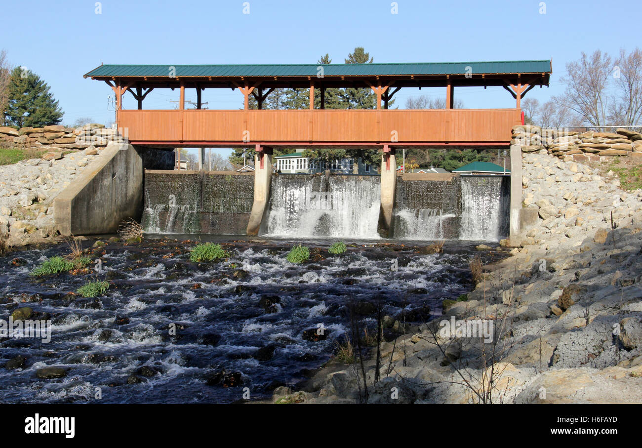 Wooden bridge over a river dam against a blue sky background Stock ...