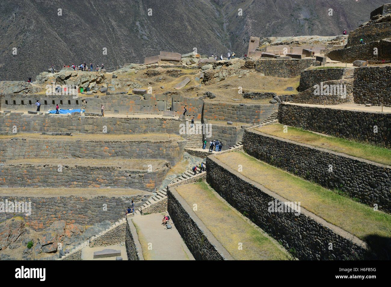 People climb the agricultural terraces at the Inca ruins of ...