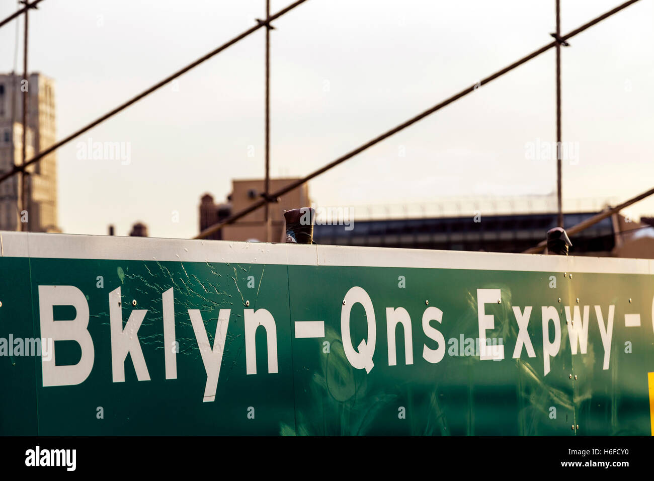 Sign above a highway depicting the way to the Brooklyn-Queens ...