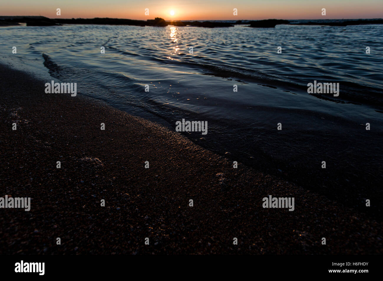 Evening light falling on the dark yellow sand at the beach Stock Photo ...