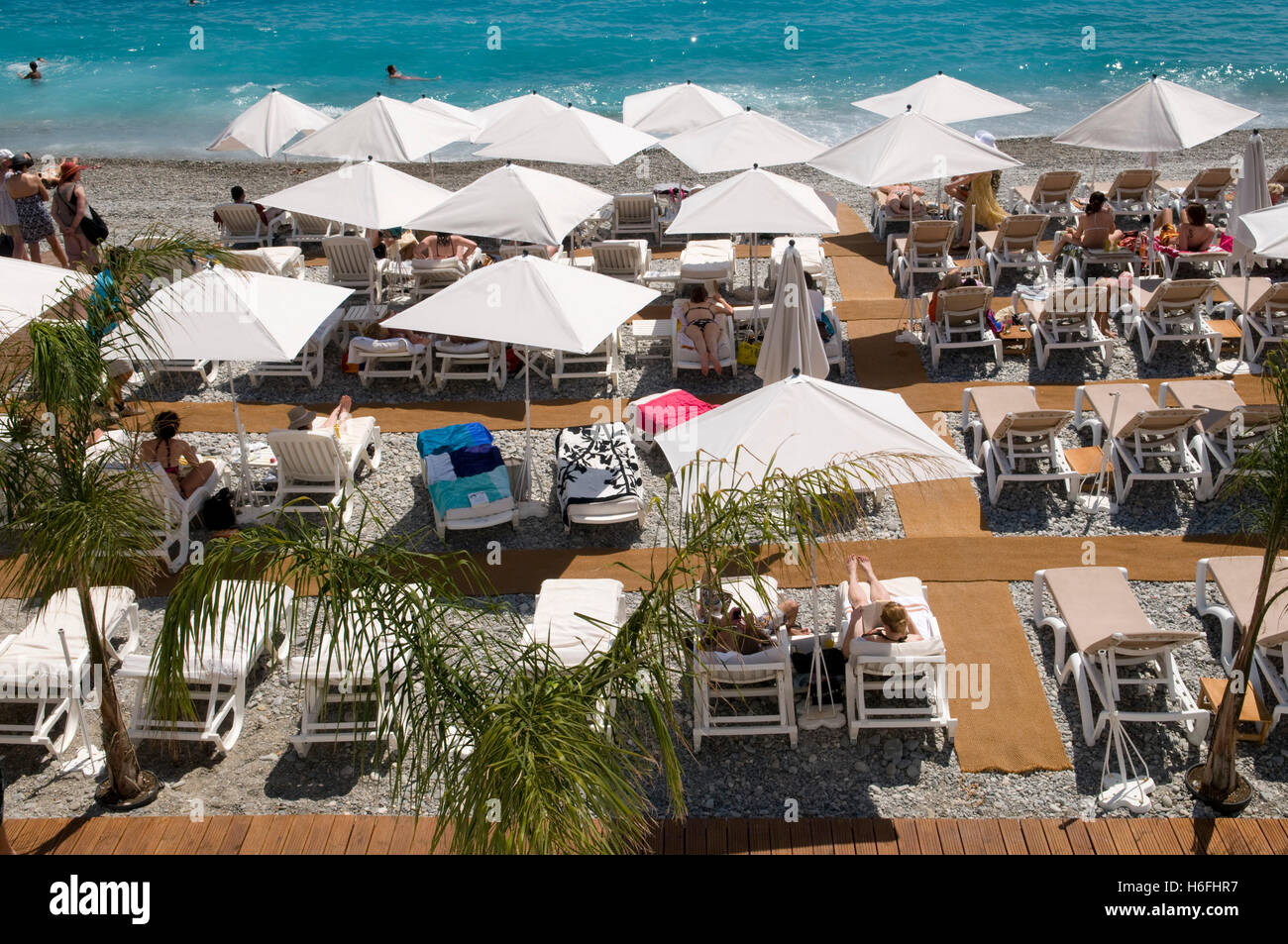 Sun umbrellas on the beach, Nice, Cote d'Azur, Provence, France, Europe ...