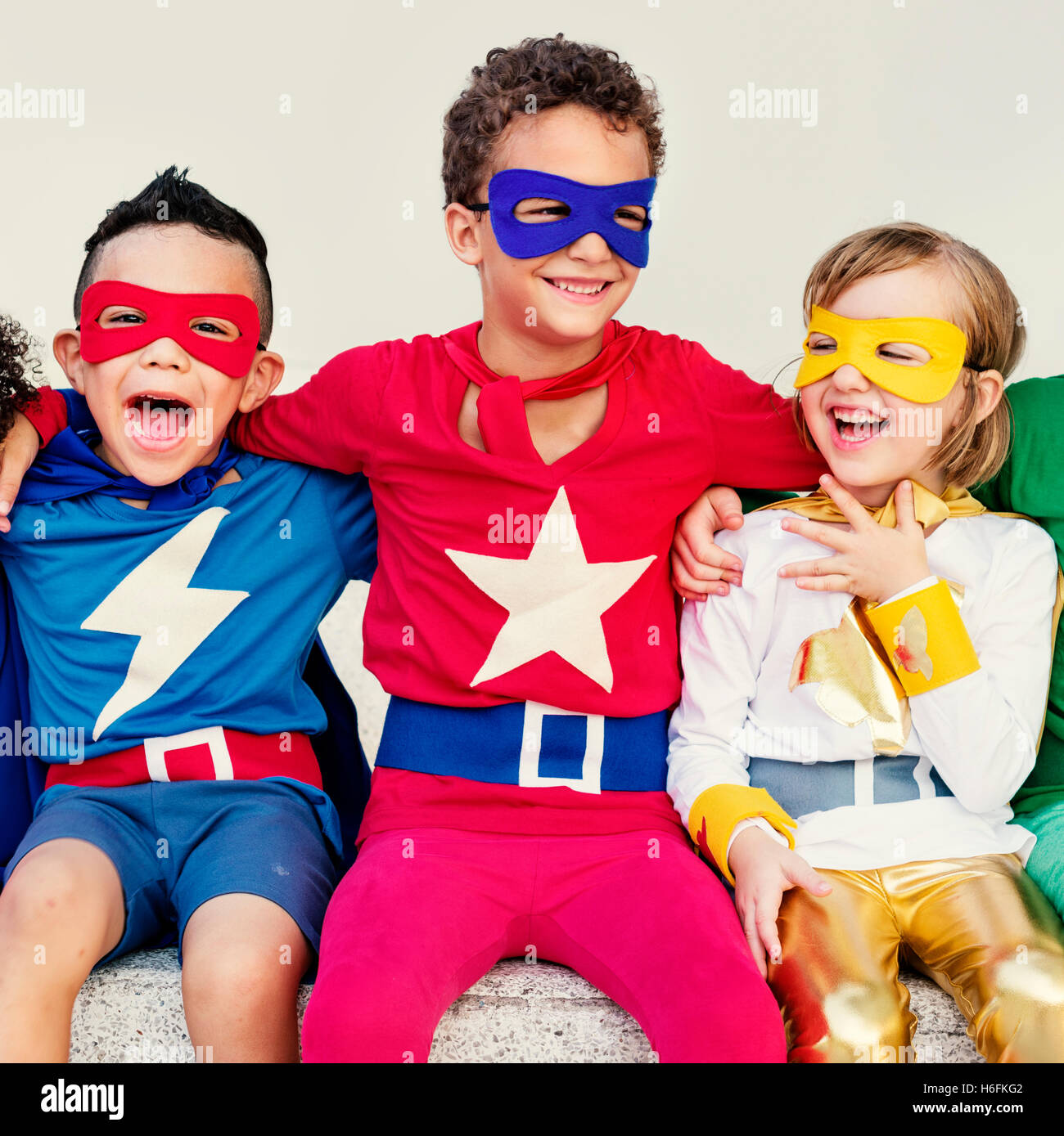 Sitting Super Hero Kids Concept Stock Photo - Alamy
