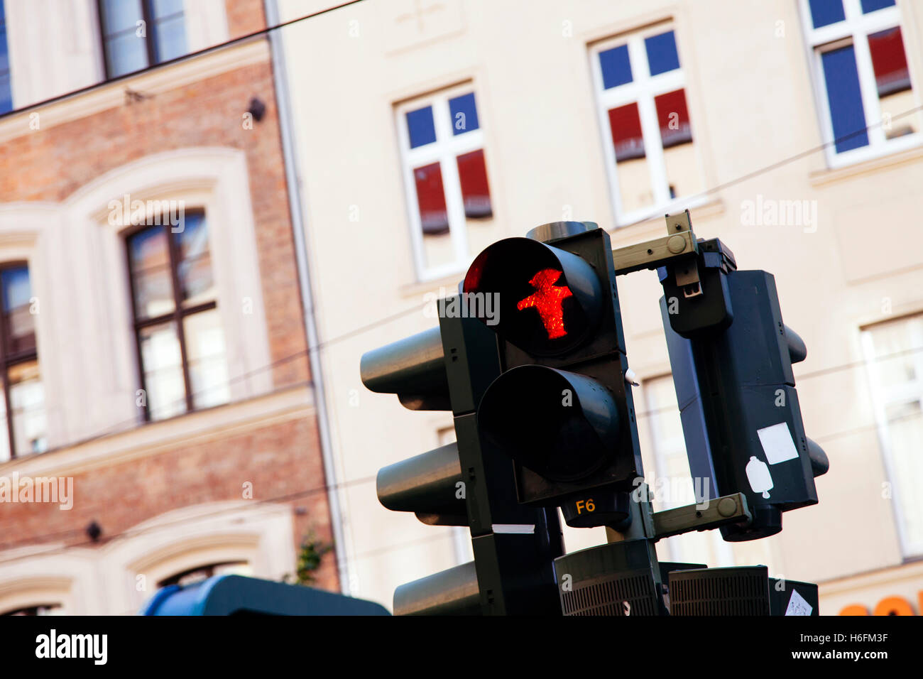 Traffic light for pedestrians indicating red in the shape of a person ...
