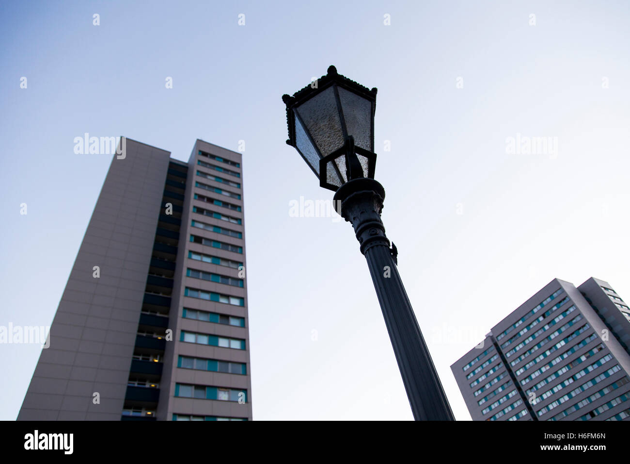 Low angle view of an apartment building lit by early morning's first ...