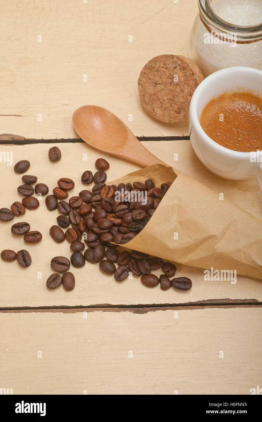 espresso coffee and beans on a paper cone cornucopia over white ...