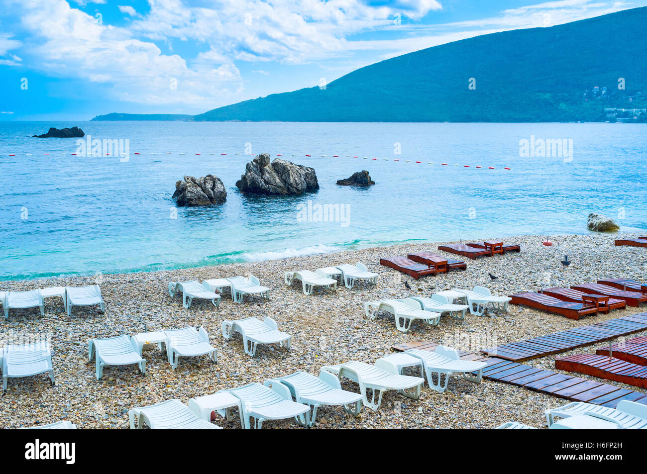 The comfortable sun beds on the central beach wait for the tourists ...