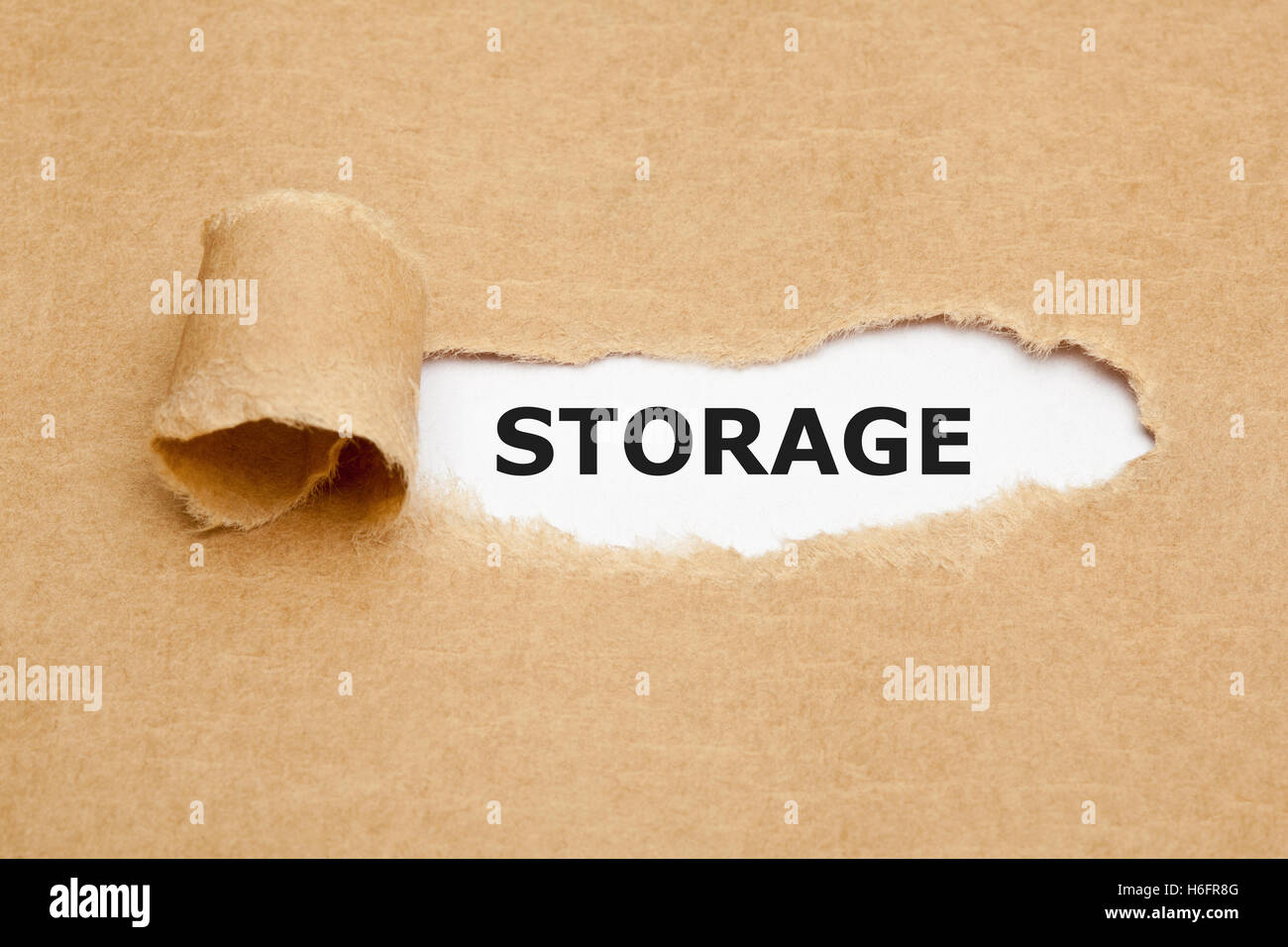 The word Storage appearing behind torn brown paper Stock Photo - Alamy