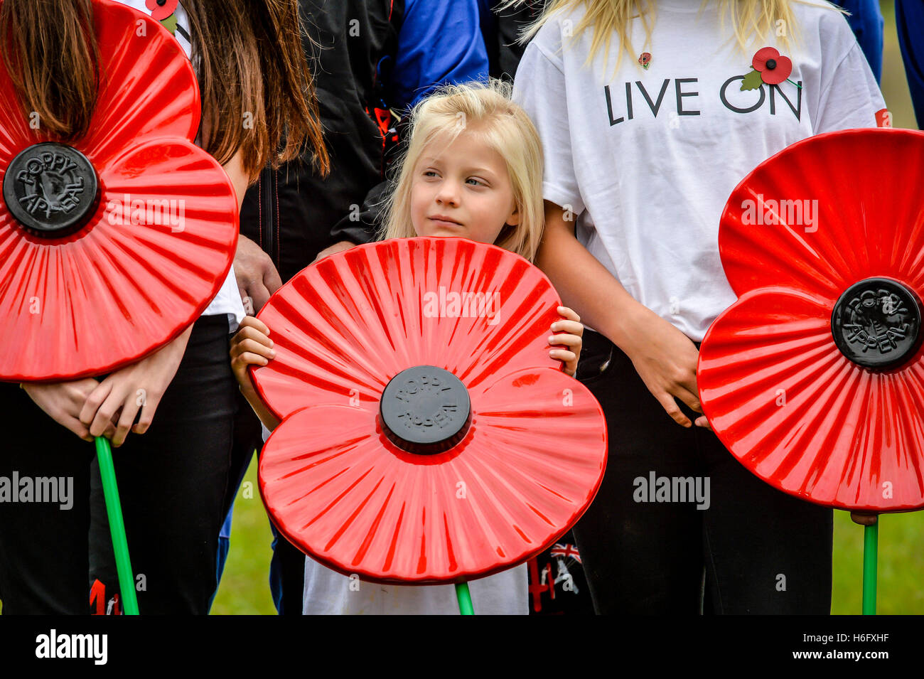 Emily Platt, five, from Tidworth, peers over a large poppy during ...