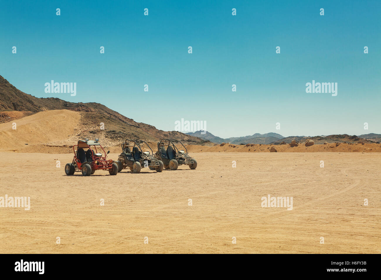 three atv standing in hot desert under clear sky Stock Photo - Alamy