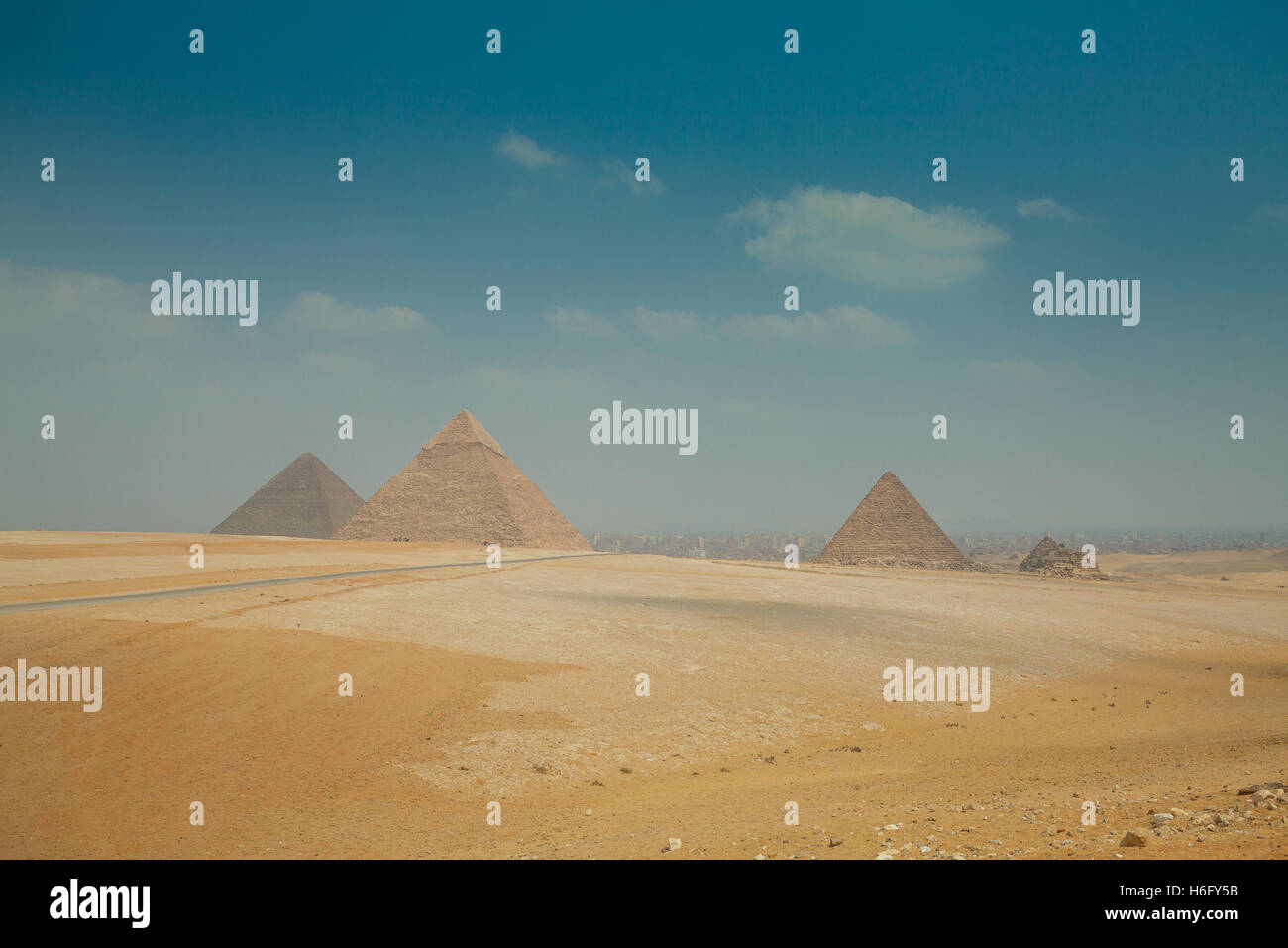 egyptian pyramids in heat yellow sands under clear sky Stock Photo - Alamy