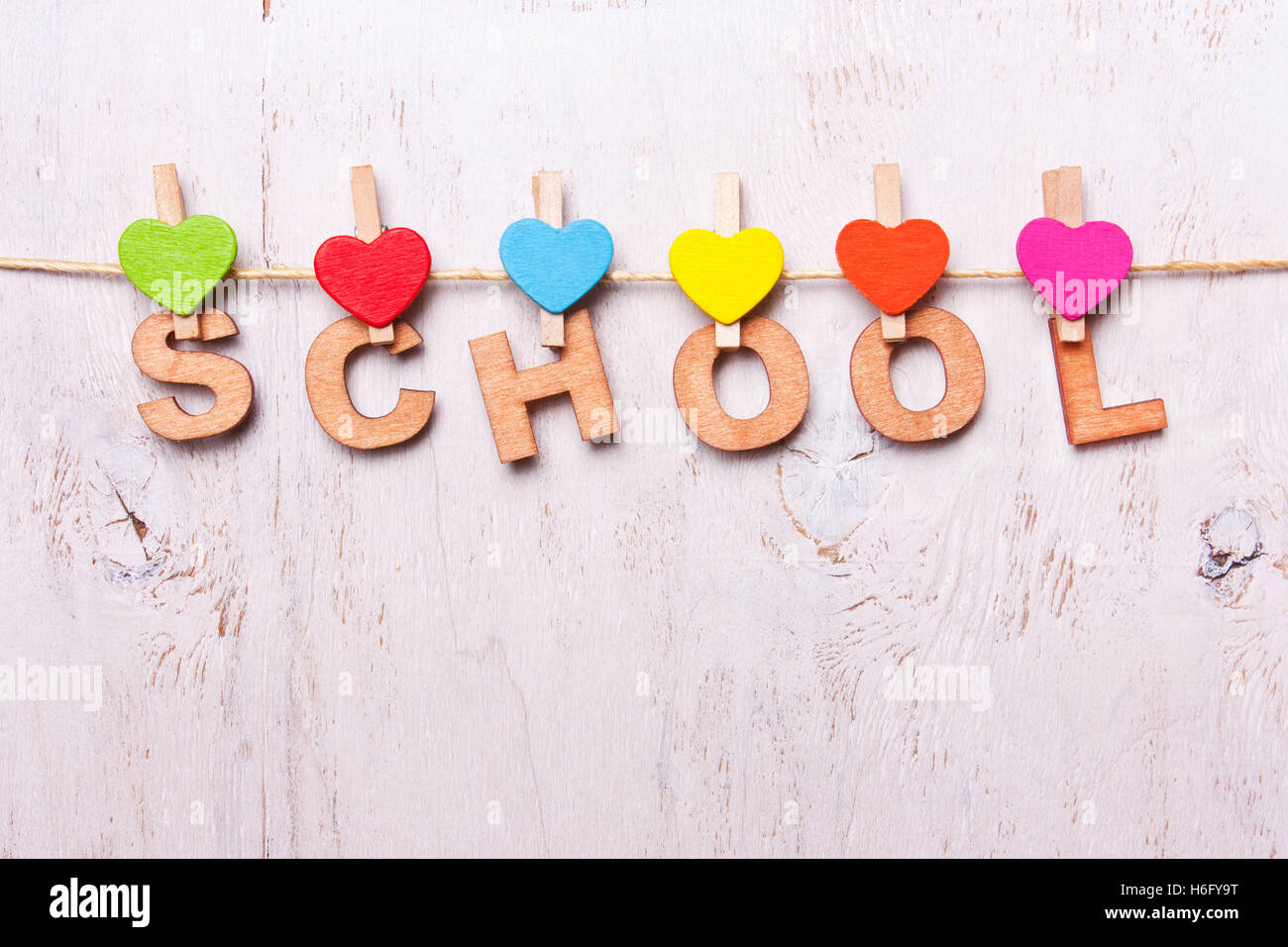 the word "school" from the wooden letters on a white background old ...