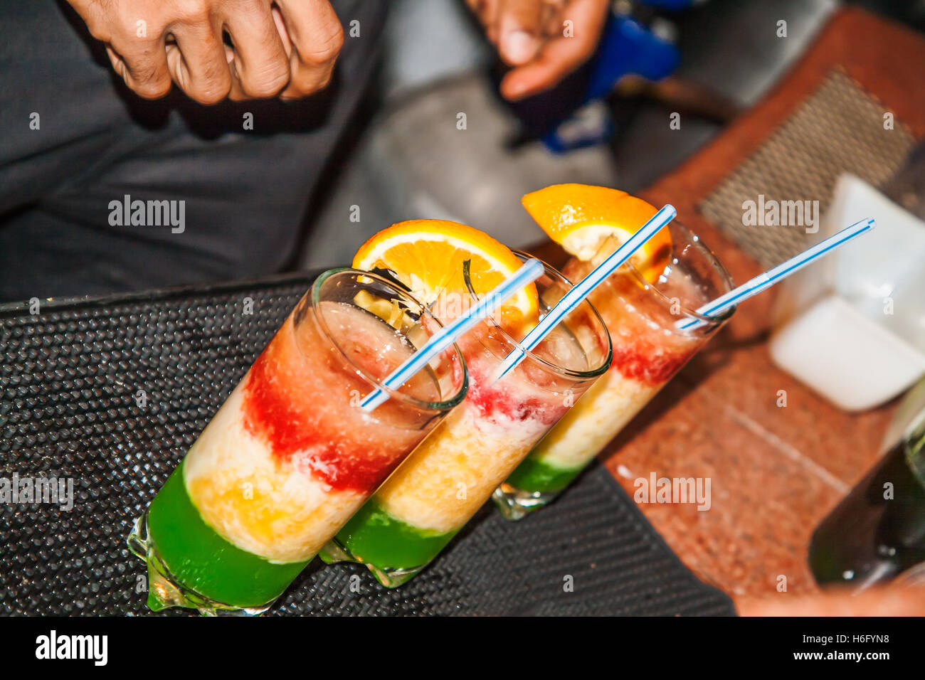 the bartender at the bar makes the three-layered cocktail Stock Photo ...