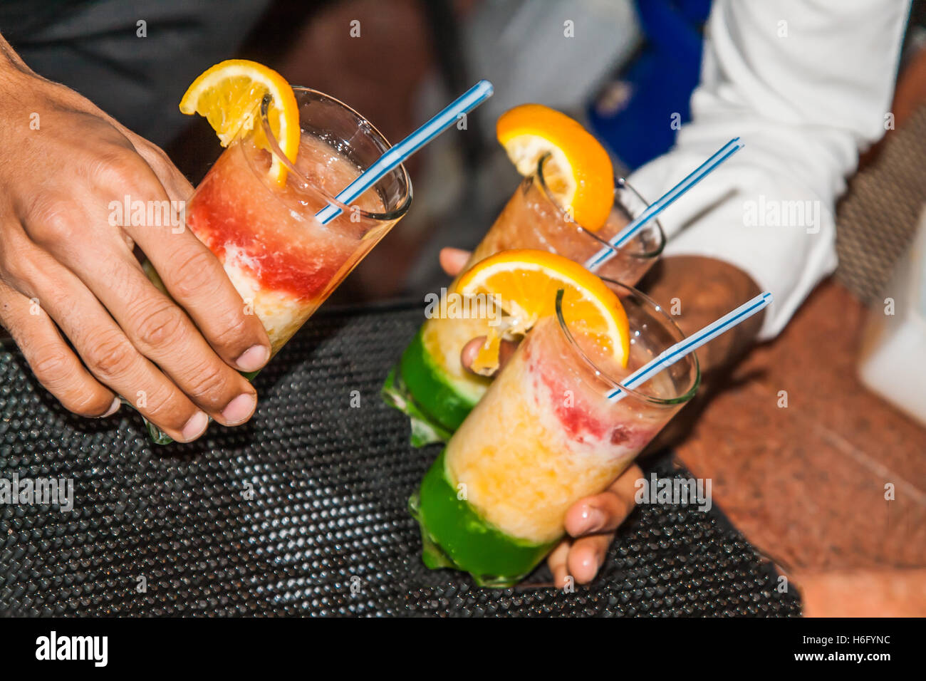 the bartender at the bar makes the three-layered cocktail Stock Photo ...