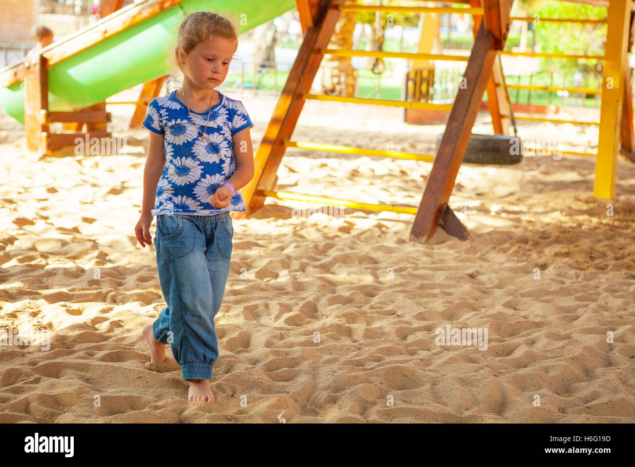 The beautiful girl playing to a sandbox Stock Photo - Alamy