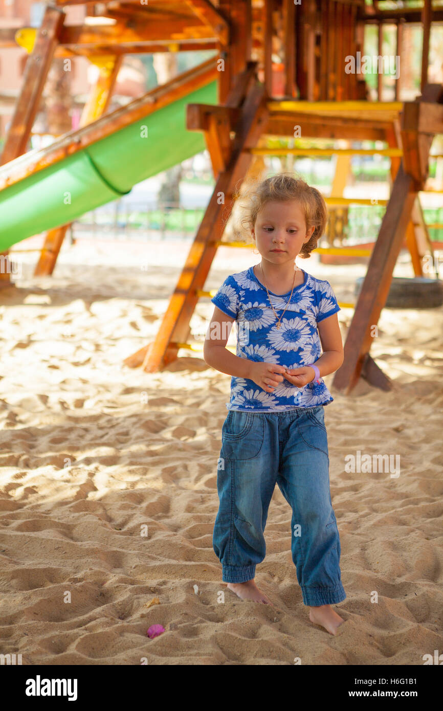 The beautiful girl playing to a sandbox Stock Photo - Alamy