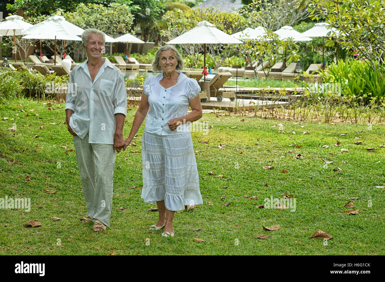 elderly couple rest at tropical resort Stock Photo - Alamy