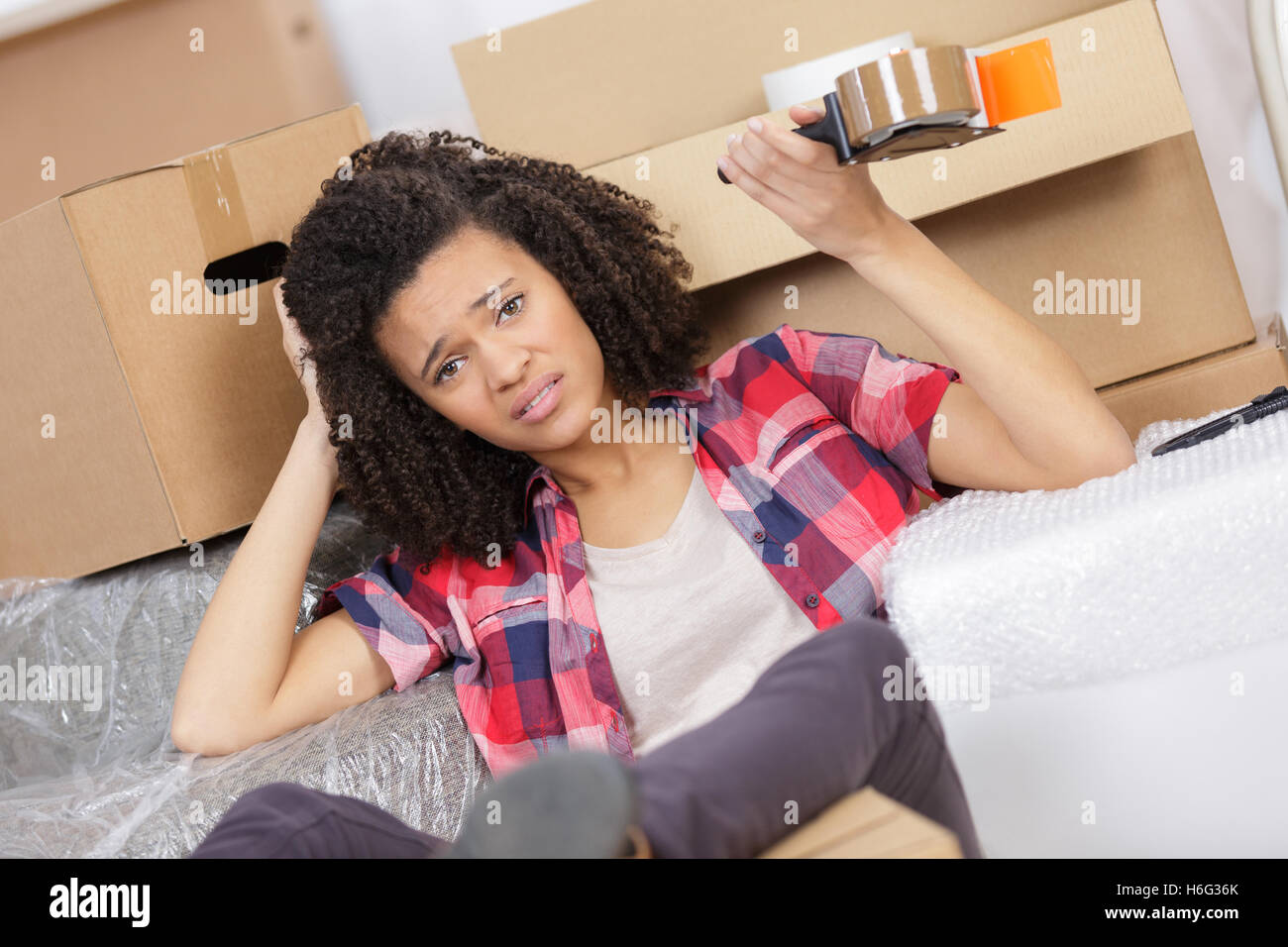 exhausted woman with packages for house moving Stock Photo - Alamy