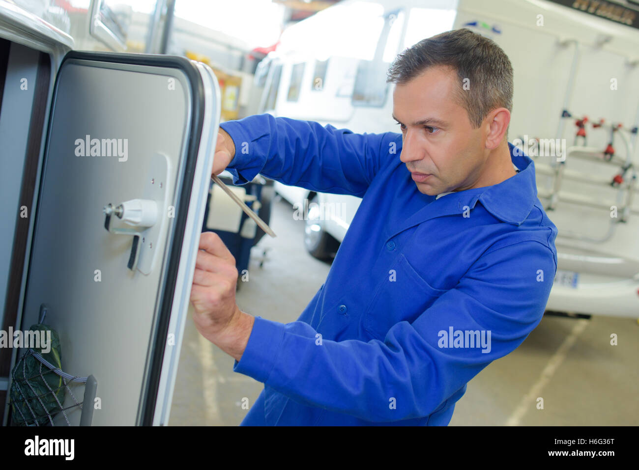 Mechanic working on camper van Stock Photo - Alamy