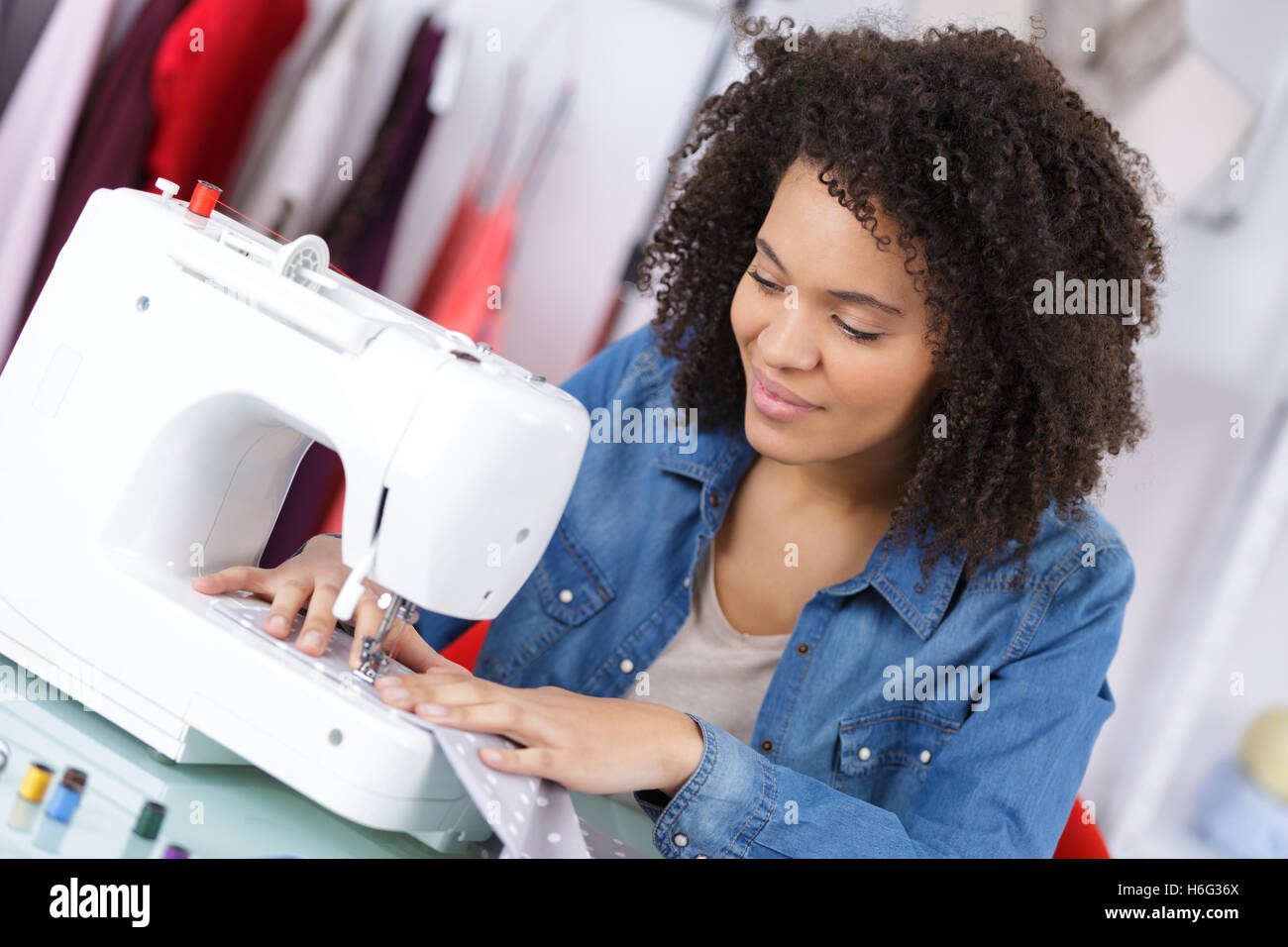 woman sewing a fabric Stock Photo - Alamy