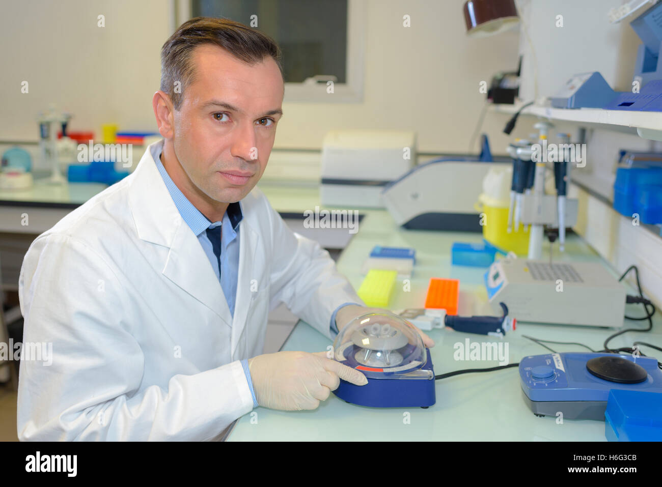 biochemist posing holding an equipment Stock Photo - Alamy