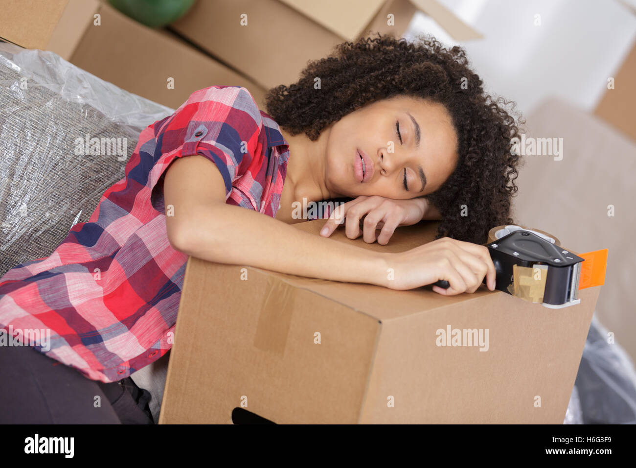 woman sleeping on carton Stock Photo - Alamy