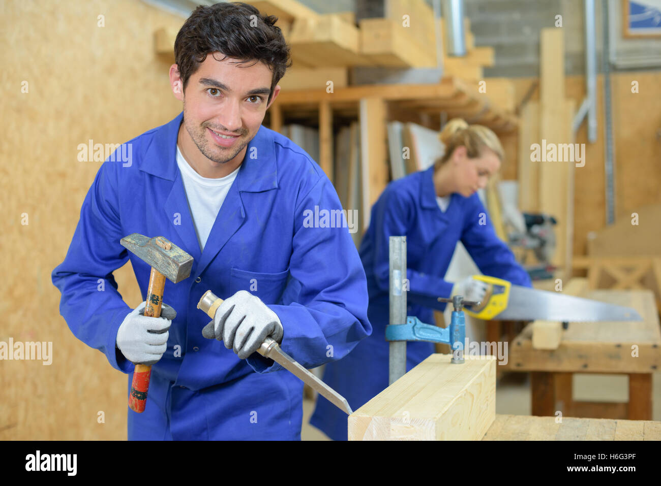 Young carpenter using hammer and chisel Stock Photo - Alamy