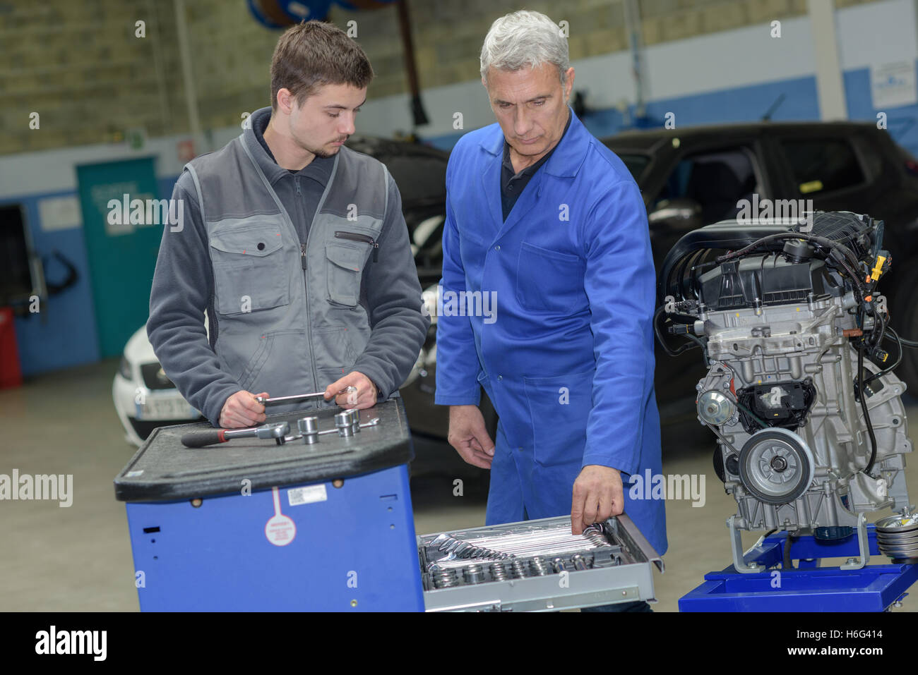 auto mechanic shows trainee maintenance of car engine Stock Photo - Alamy
