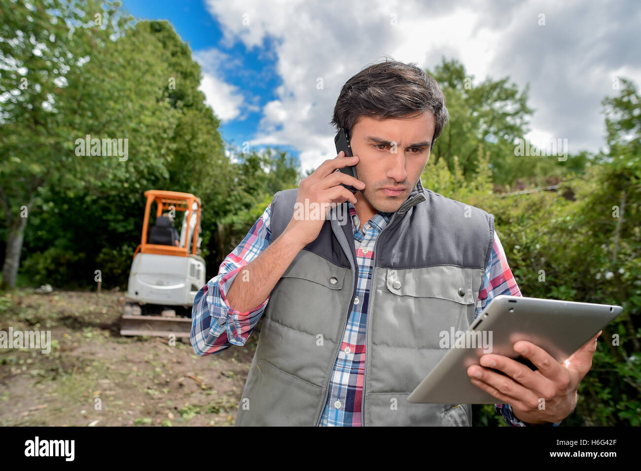 Foreman taking a call Stock Photo - Alamy
