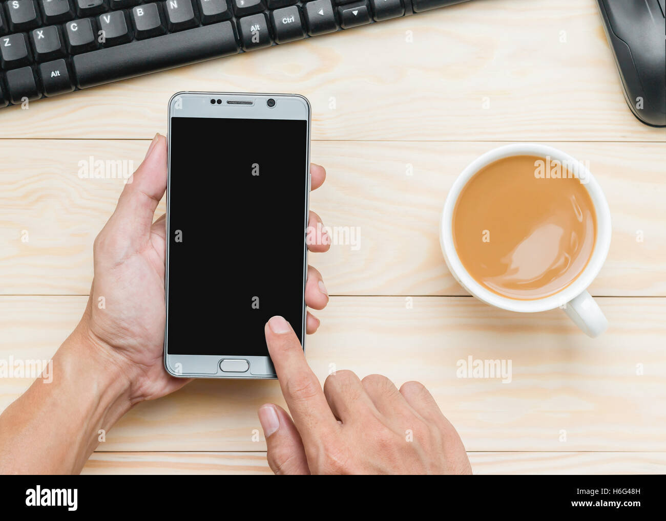 hand using smartphone on wooden background. top view Stock Photo - Alamy