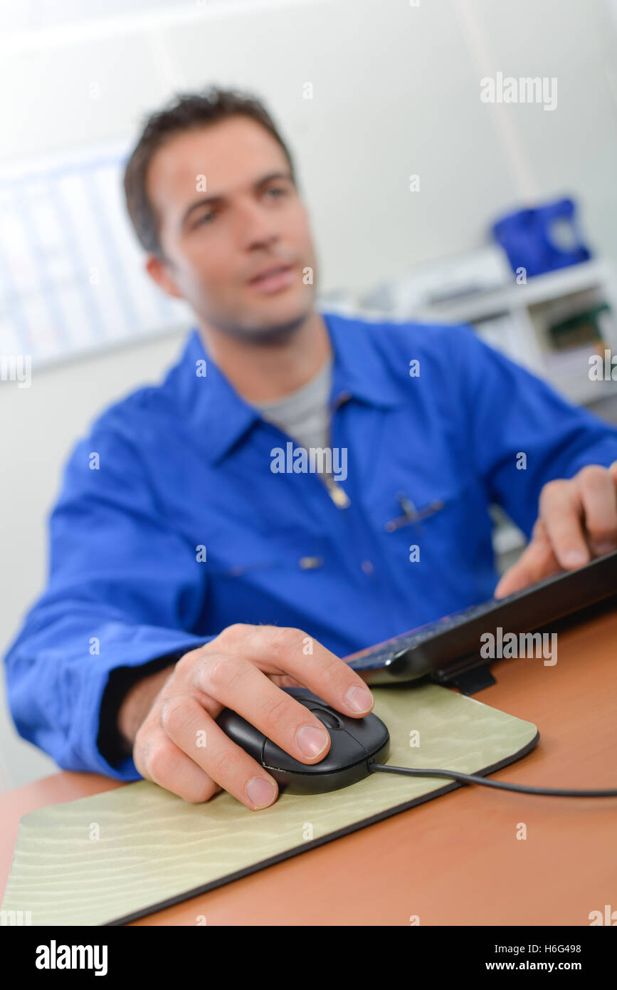 Man on computer, hand on mouse Stock Photo - Alamy