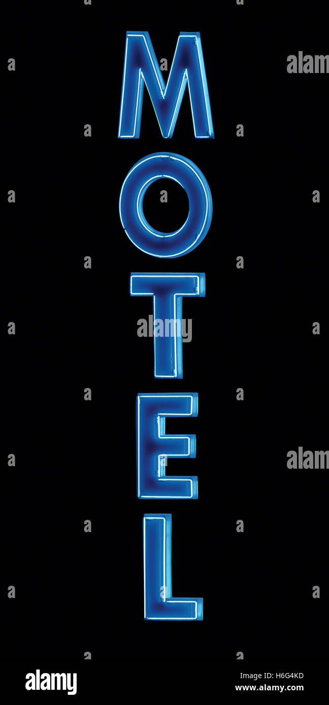 Blue Neon Motel sign, lit up at night, vertical black isolated closeup ...