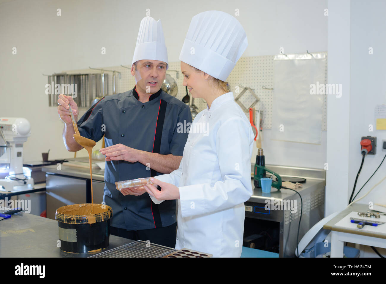 chef discussing with his commis chef Stock Photo - Alamy