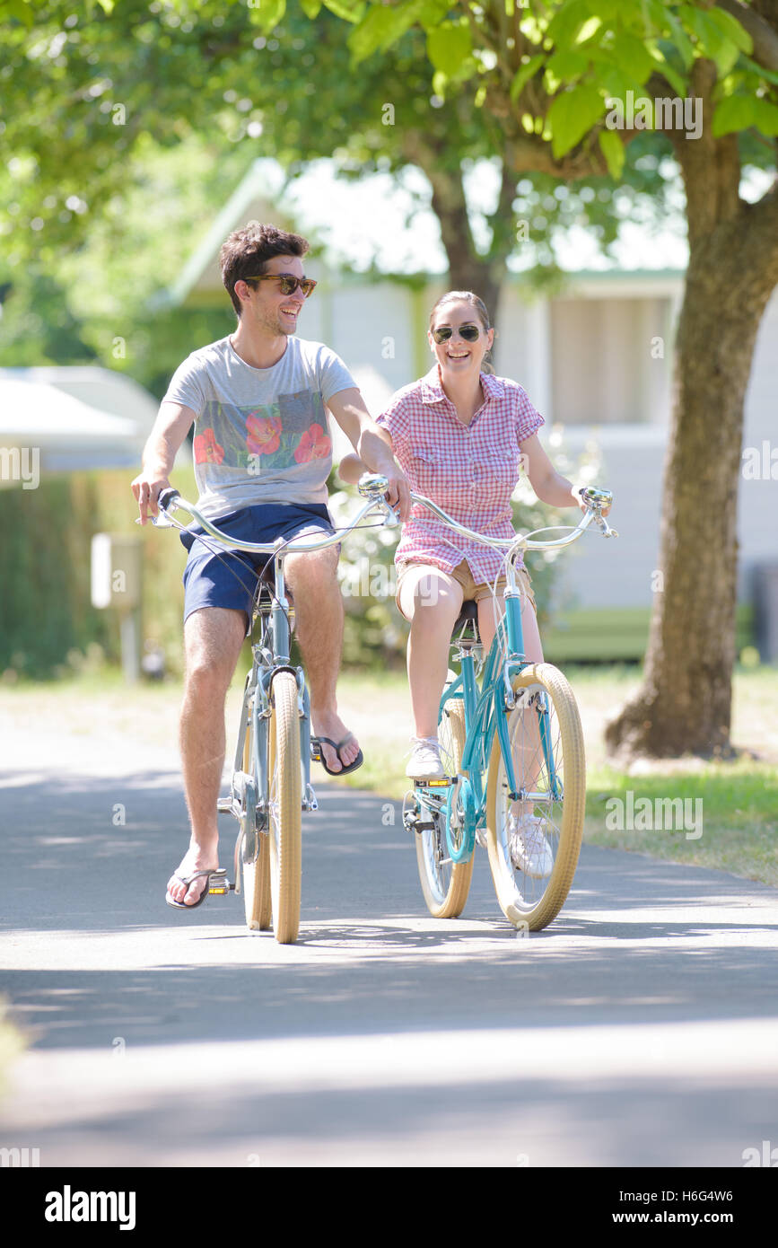 Young man woman riding bikes hi-res stock photography and images - Alamy